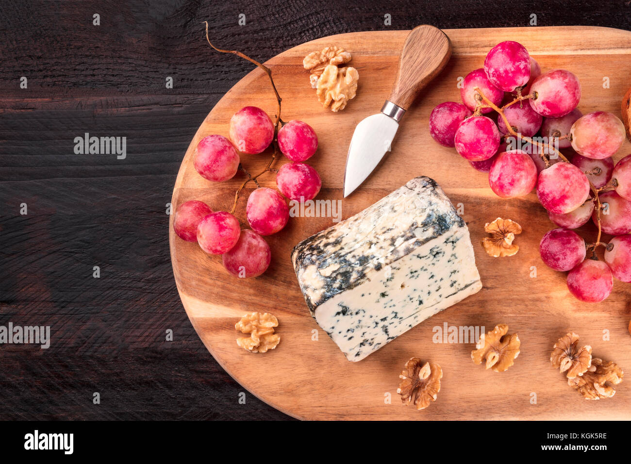Blue cheese with grapes and copyspace on rustic textures Stock Photo ...