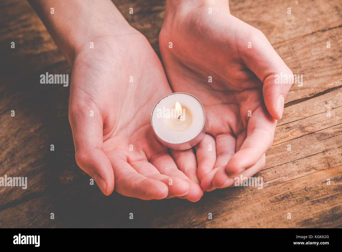 hands that offer the flame of a candle - sharing concept Stock Photo ...