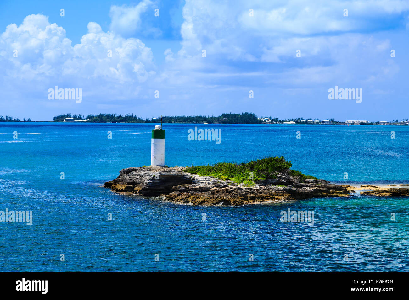 Beacon on Rocks Over blue Water Stock Photo - Alamy