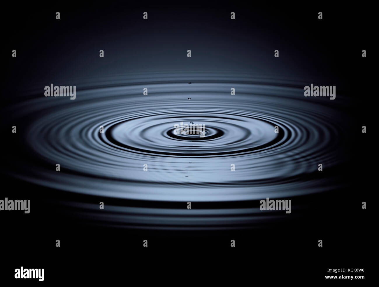 Water Drops dripping into water splashes Stock Photo - Alamy