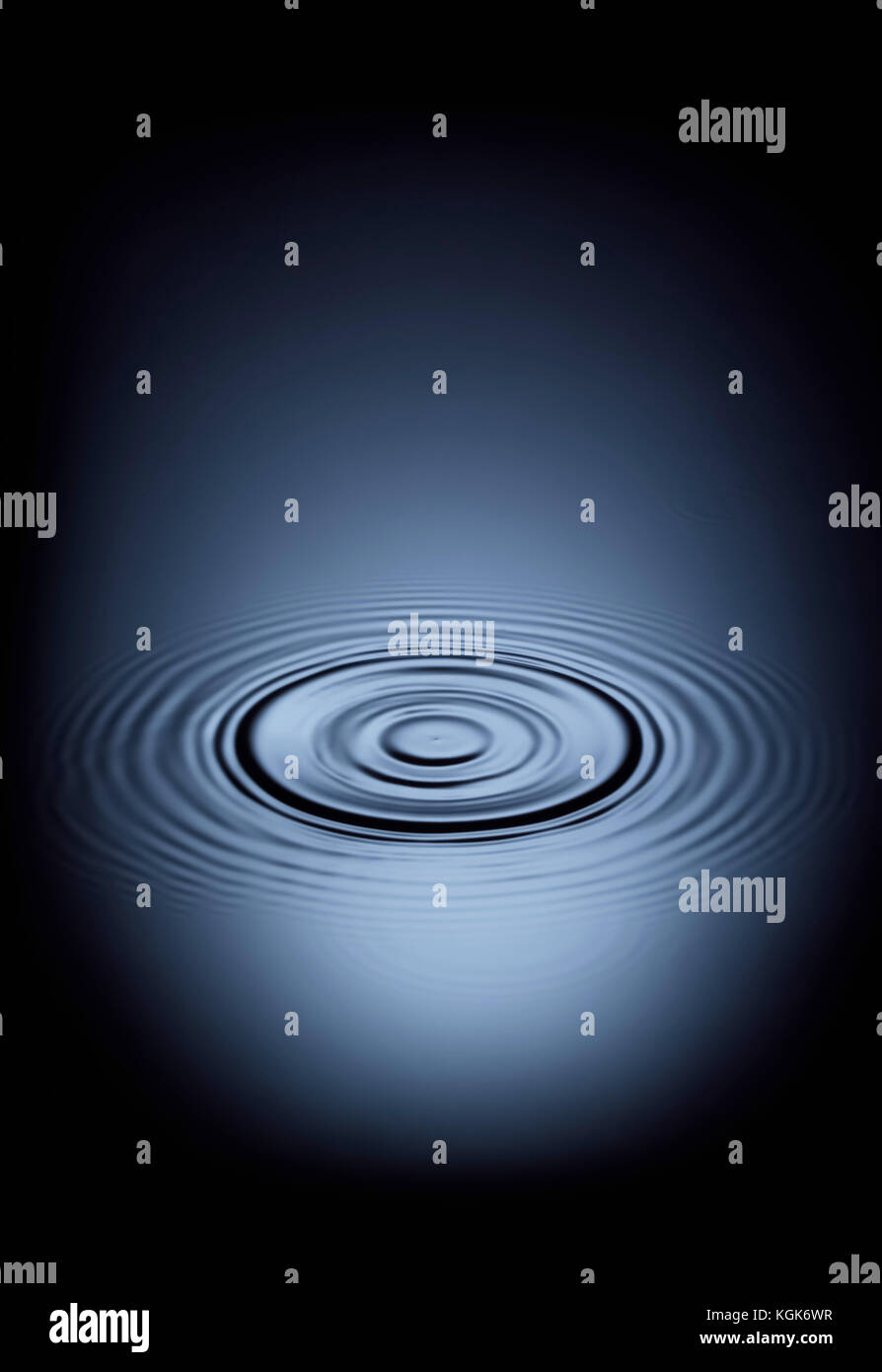 Droplet falling in blue water Stock Photo - Alamy