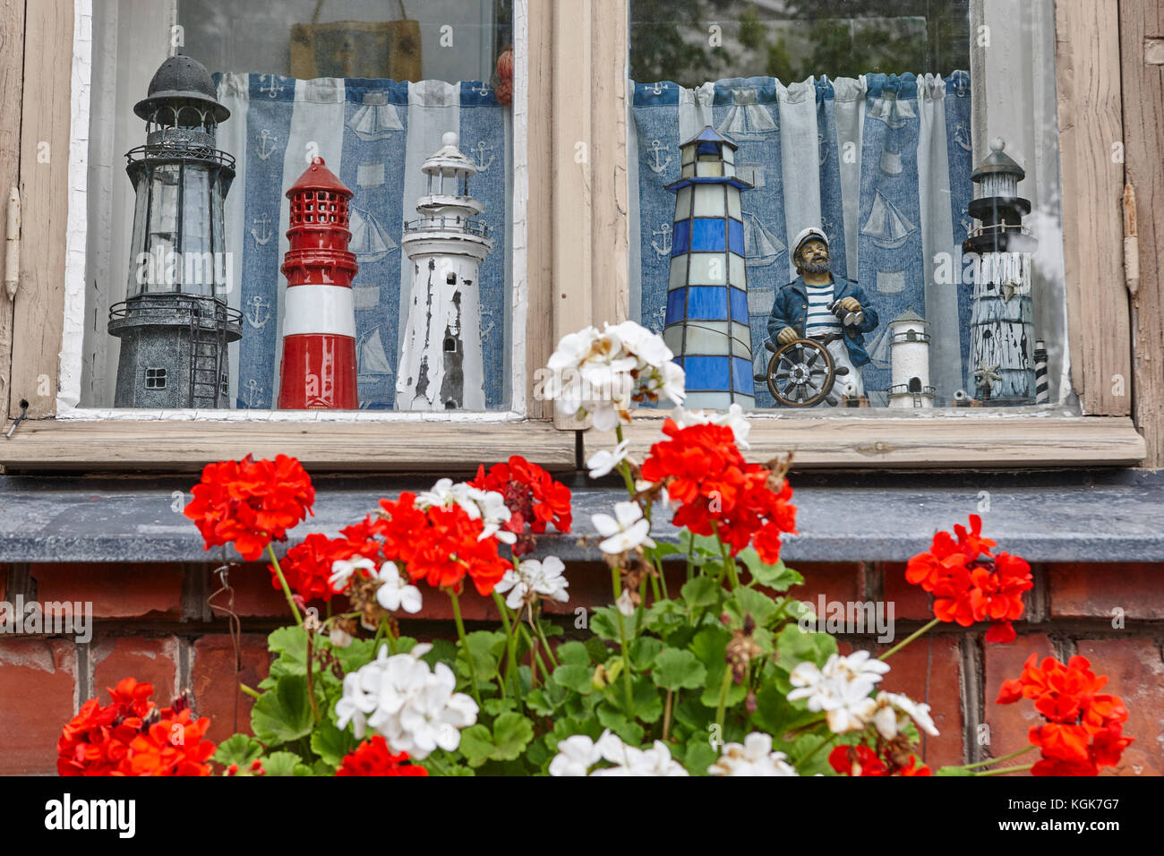Old brick facade with wooden window and model lighthouses. Horizontal ...