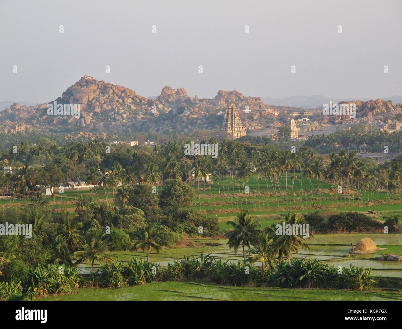 Unique landscape in Karnataka, India. Rice fields, ancient town Hampi ...