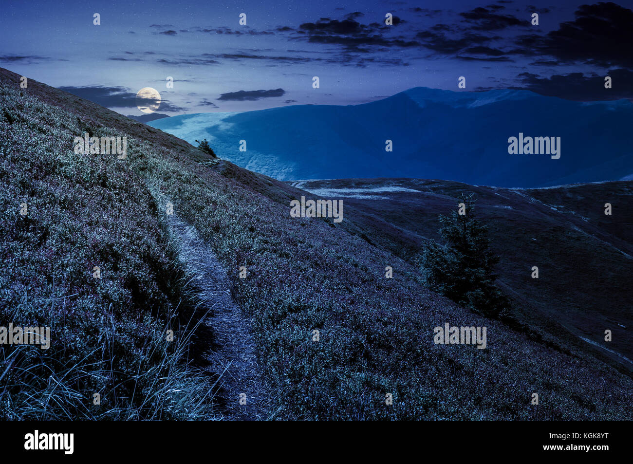 path though mountain hills and ridge at night in full moon light ...