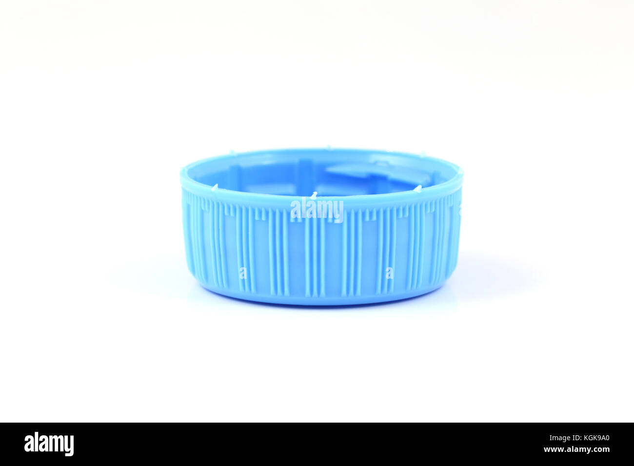 blue plastic bottle cap close up in studio macro on white background ...