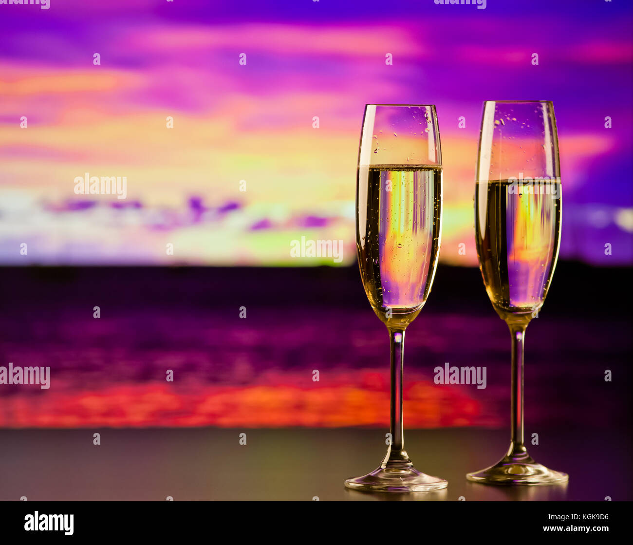 two champagne glasses at sunset Stock Photo - Alamy
