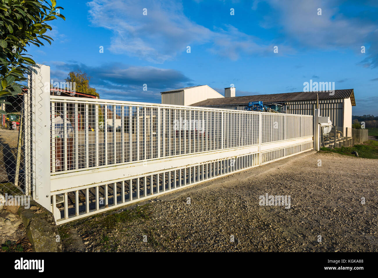 Long, sliding metal farm gate - France Stock Photo - Alamy