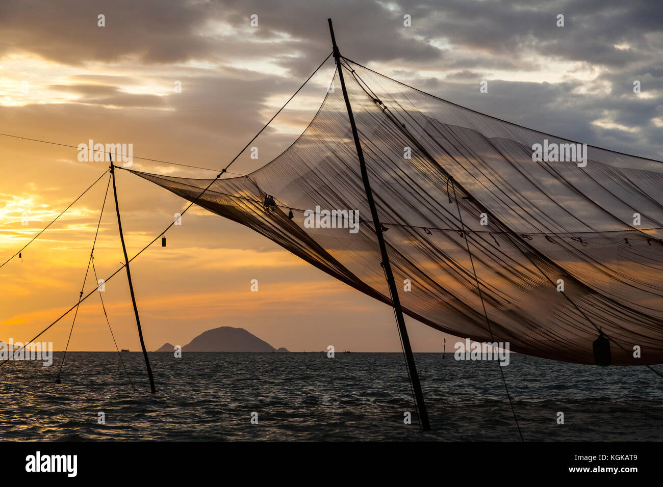 Traditional hanging fishing net in the sea, at the entrance to Thu Bon ...