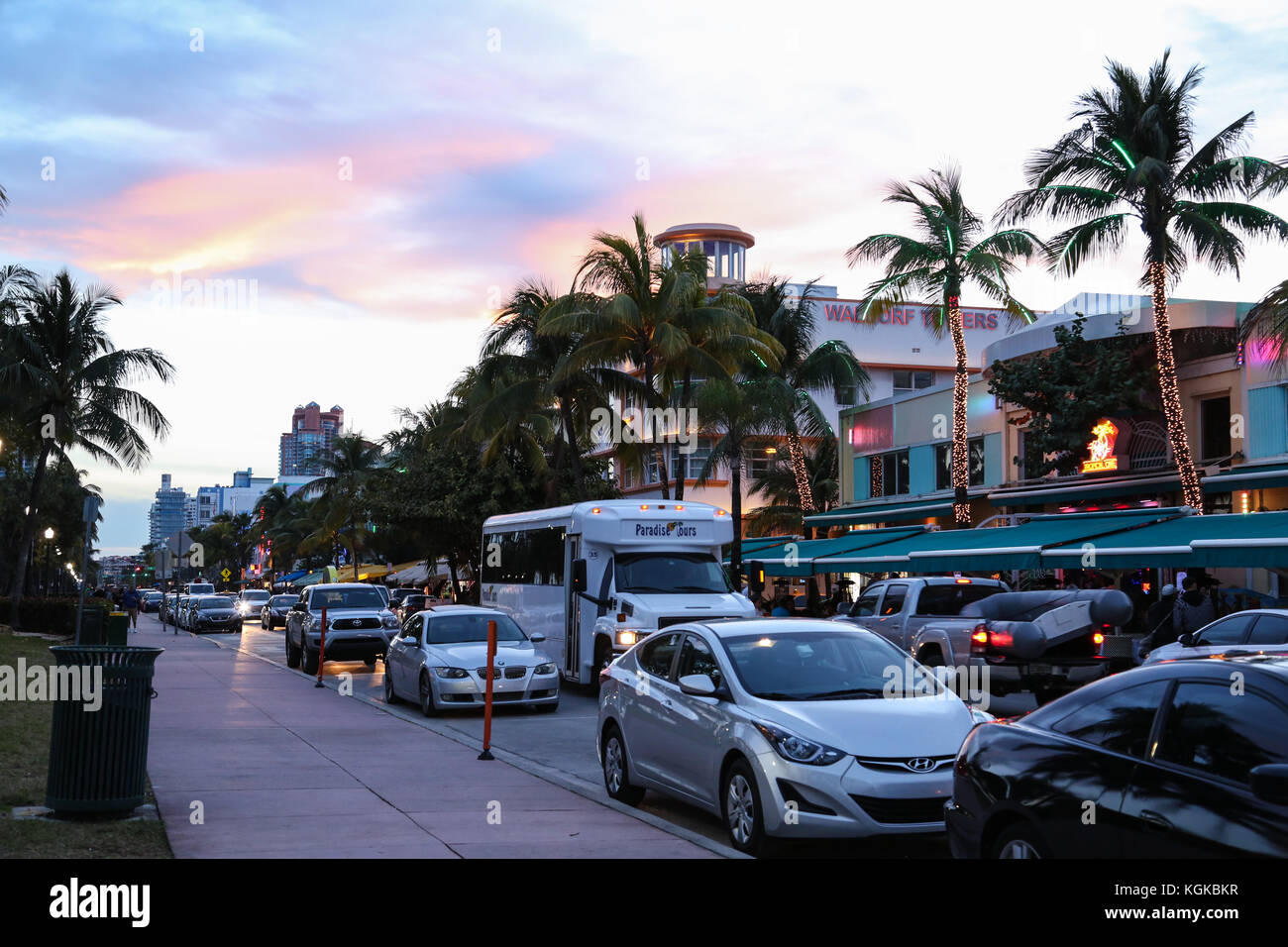 Cars and traffic on Ocean Drive at dusk, with a sunset behind, in South ...