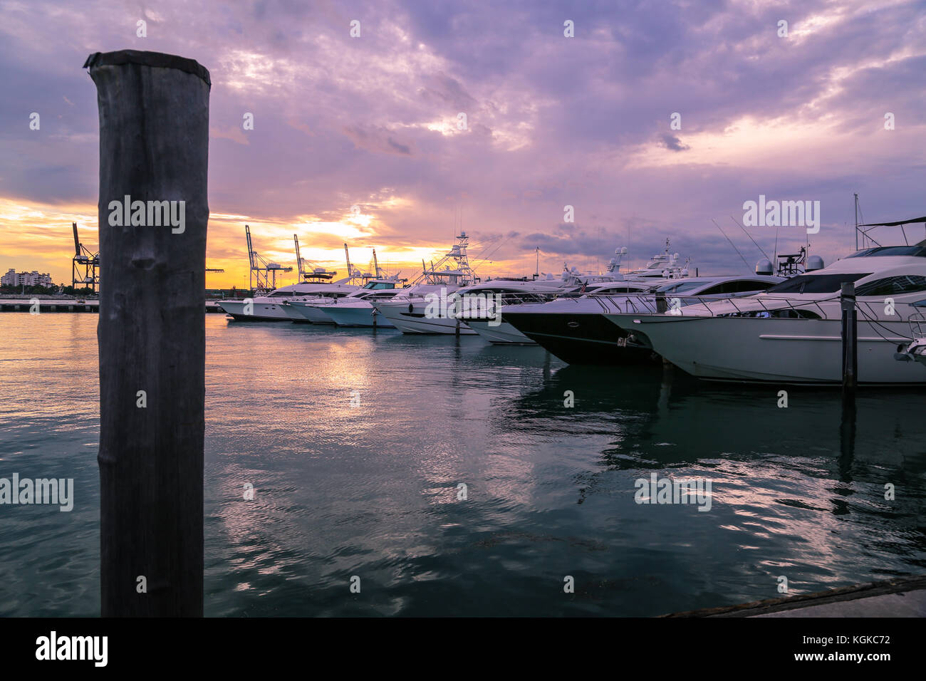 Tropical purple and orange sunset over yachts in the marina at South ...