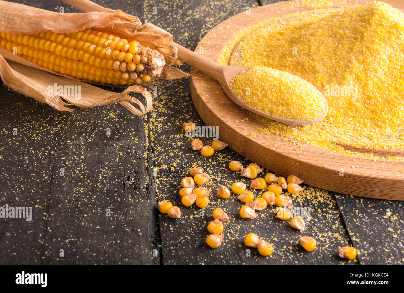 Food ingredients theme image with a corn cob, grains and corn flour on ...