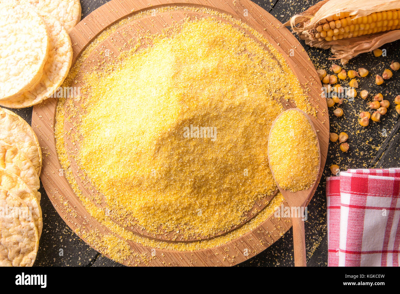 High angle view image with a pile of corn flour on a round wooden board ...