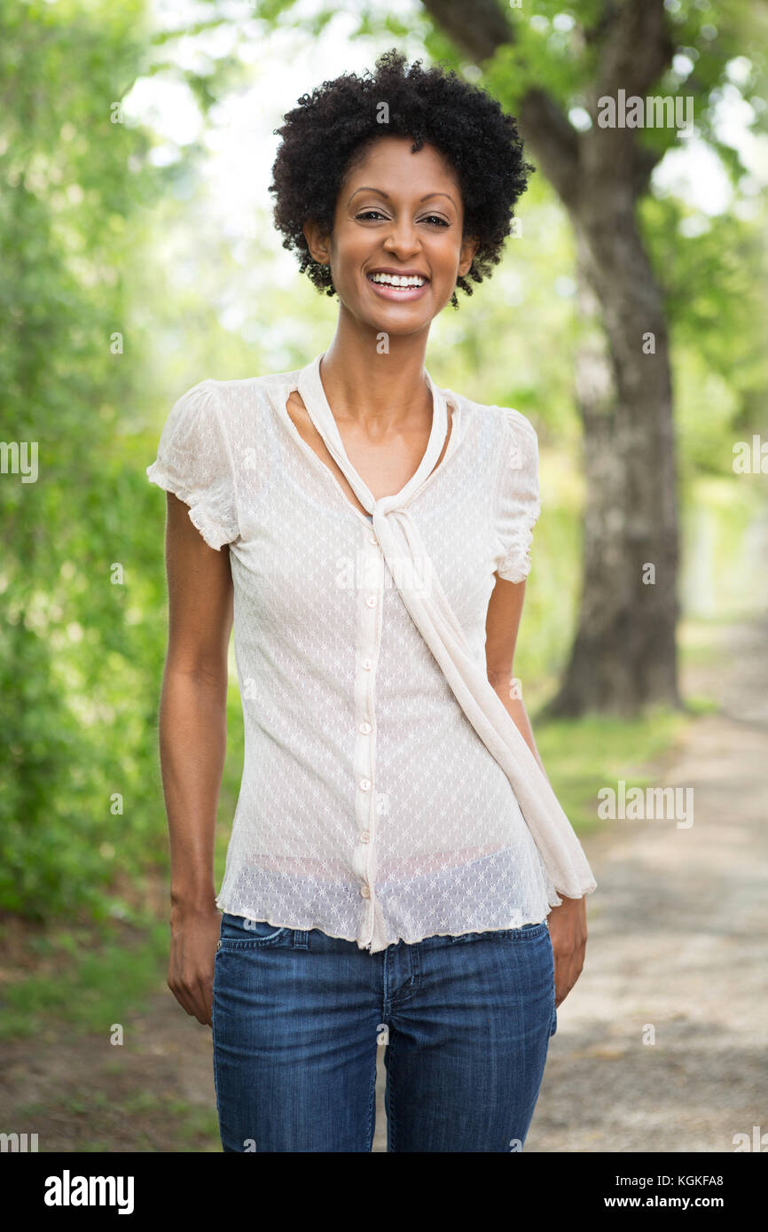Beautiful woman smiling outside Stock Photo - Alamy