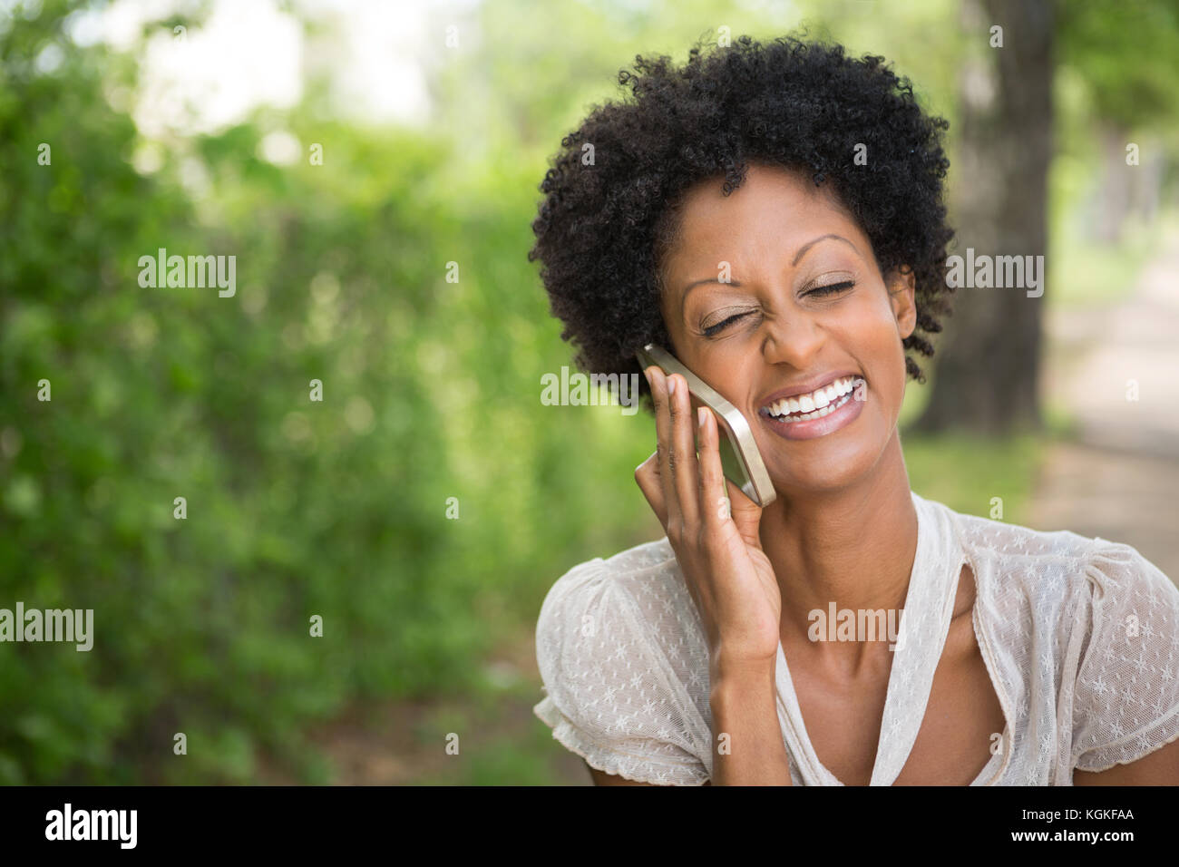 Beautiful woman smiling outside Stock Photo - Alamy