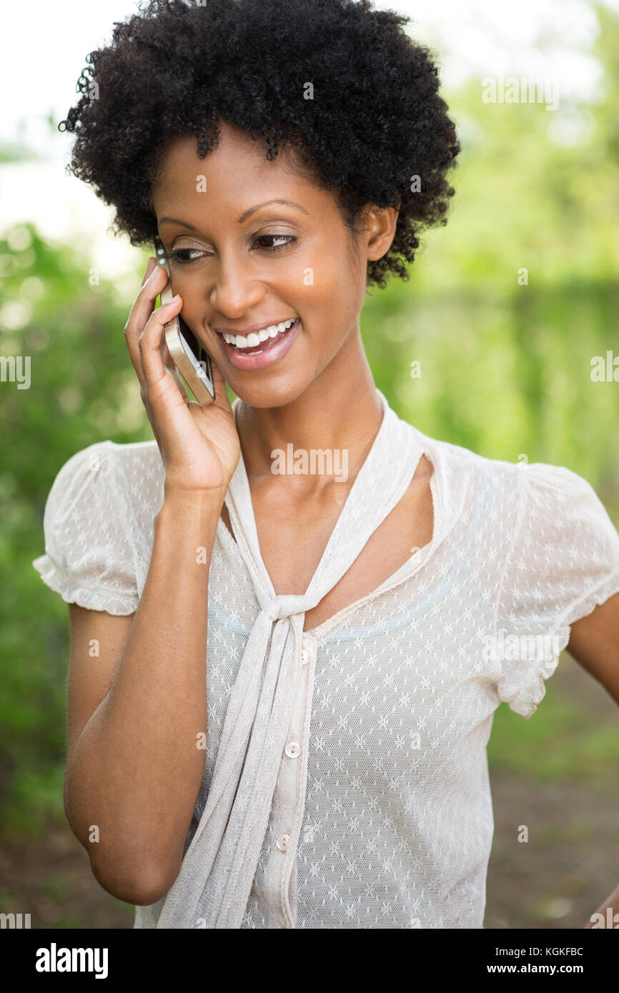 Beautiful woman smiling outside Stock Photo - Alamy