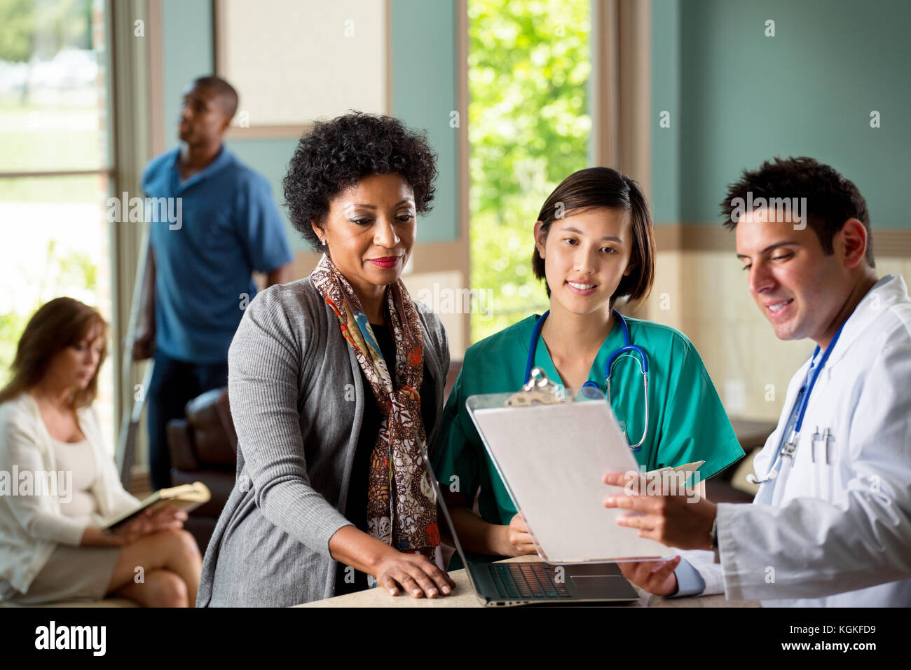 Medical team talking with patients Stock Photo - Alamy