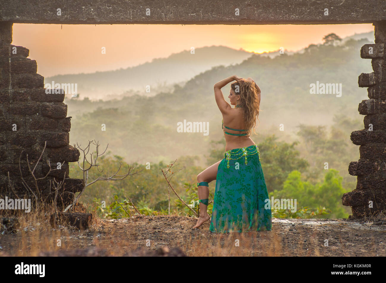 A woman preforming belly dance in front of a sunrise Stock Photo - Alamy