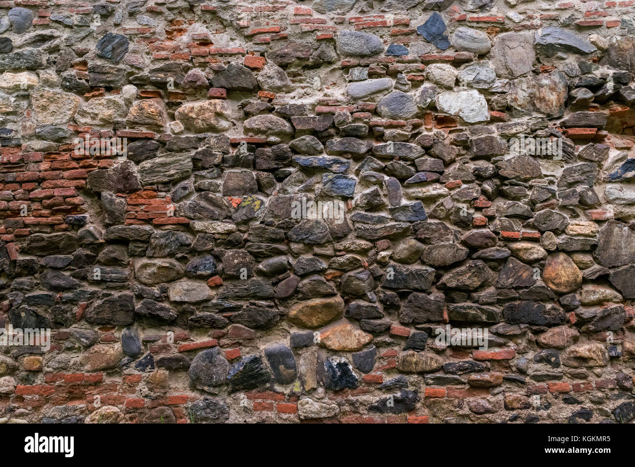 Medieval wall built of stone and bricks, background texture Stock Photo ...