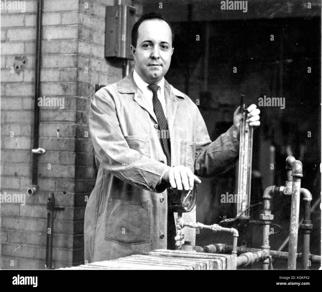 Waist up candid photograph of engineer Harold Ewald Hoelscher working ...