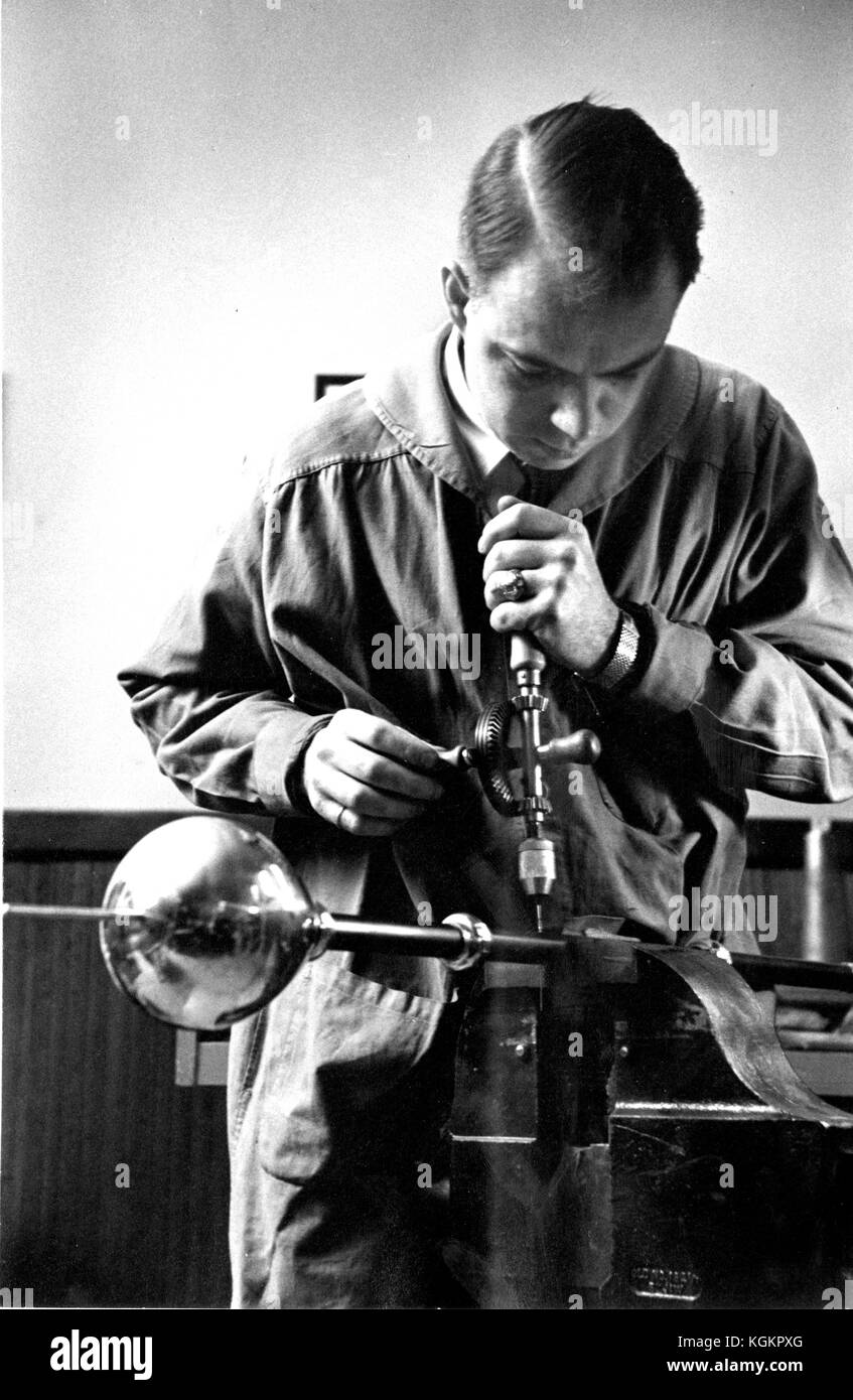 Candid of Henry Powell Jr Hopkins, a Baltimore silversmith, working on ...