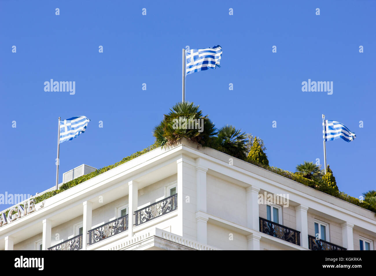 greek flags on the roof garden of a building Stock Photo - Alamy