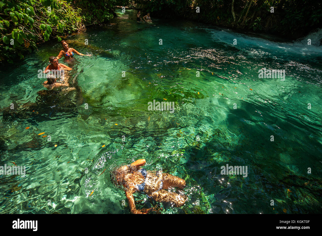 Tourists enjoying the blue waters of Formiga waterfall, Jalapão ...