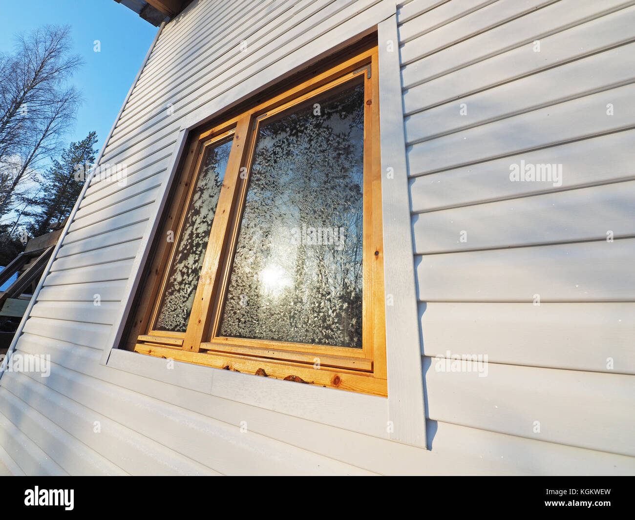 wooden window on white siding background Stock Photo - Alamy