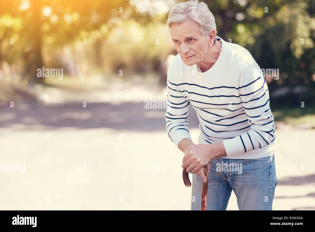 Old man using walking stick hi-res stock photography and images - Alamy