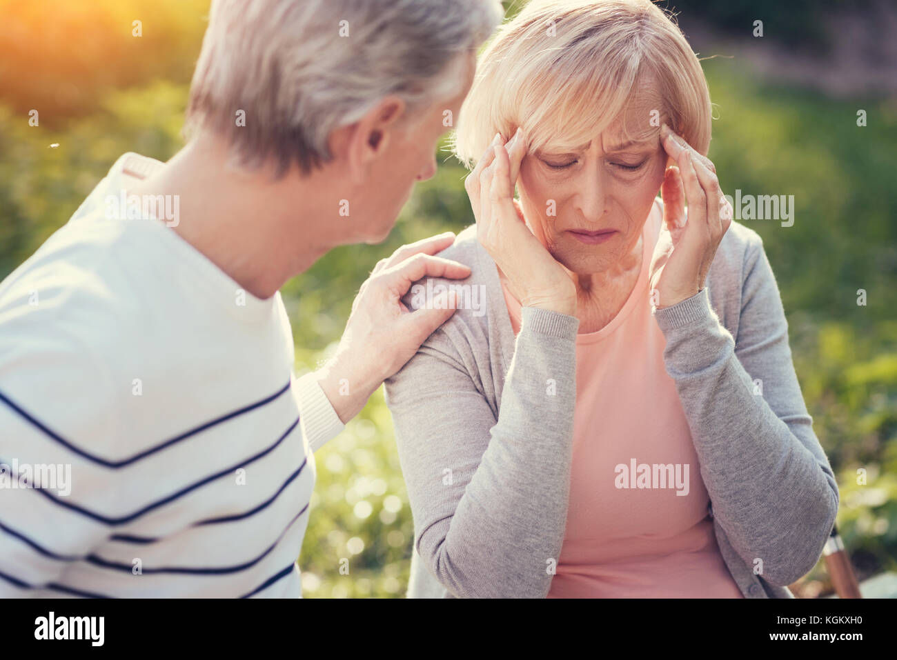 Sad elderly woman suffering from a headache Stock Photo - Alamy