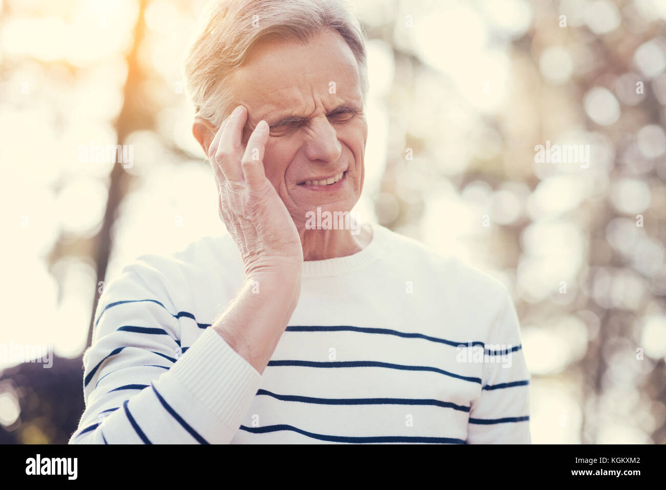 Sad cheerless man suffering from pain Stock Photo - Alamy