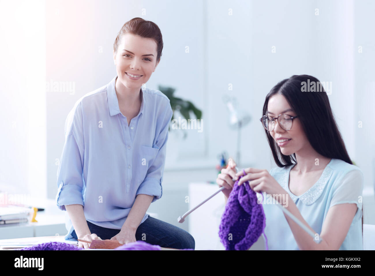 Young friendly coworkers sitting in their office Stock Photo - Alamy