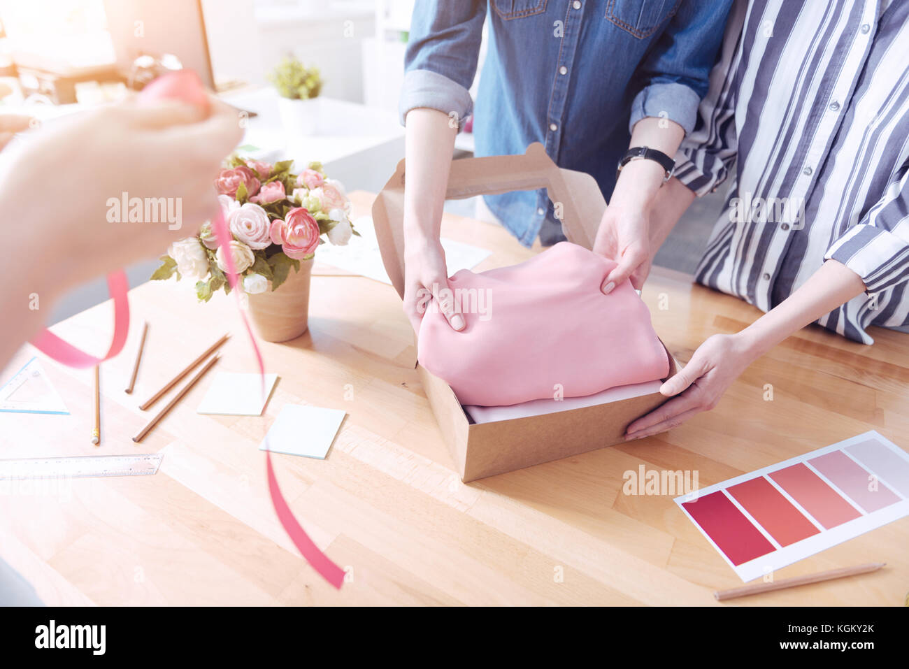 Important process of covering the parcel for a customer Stock Photo - Alamy