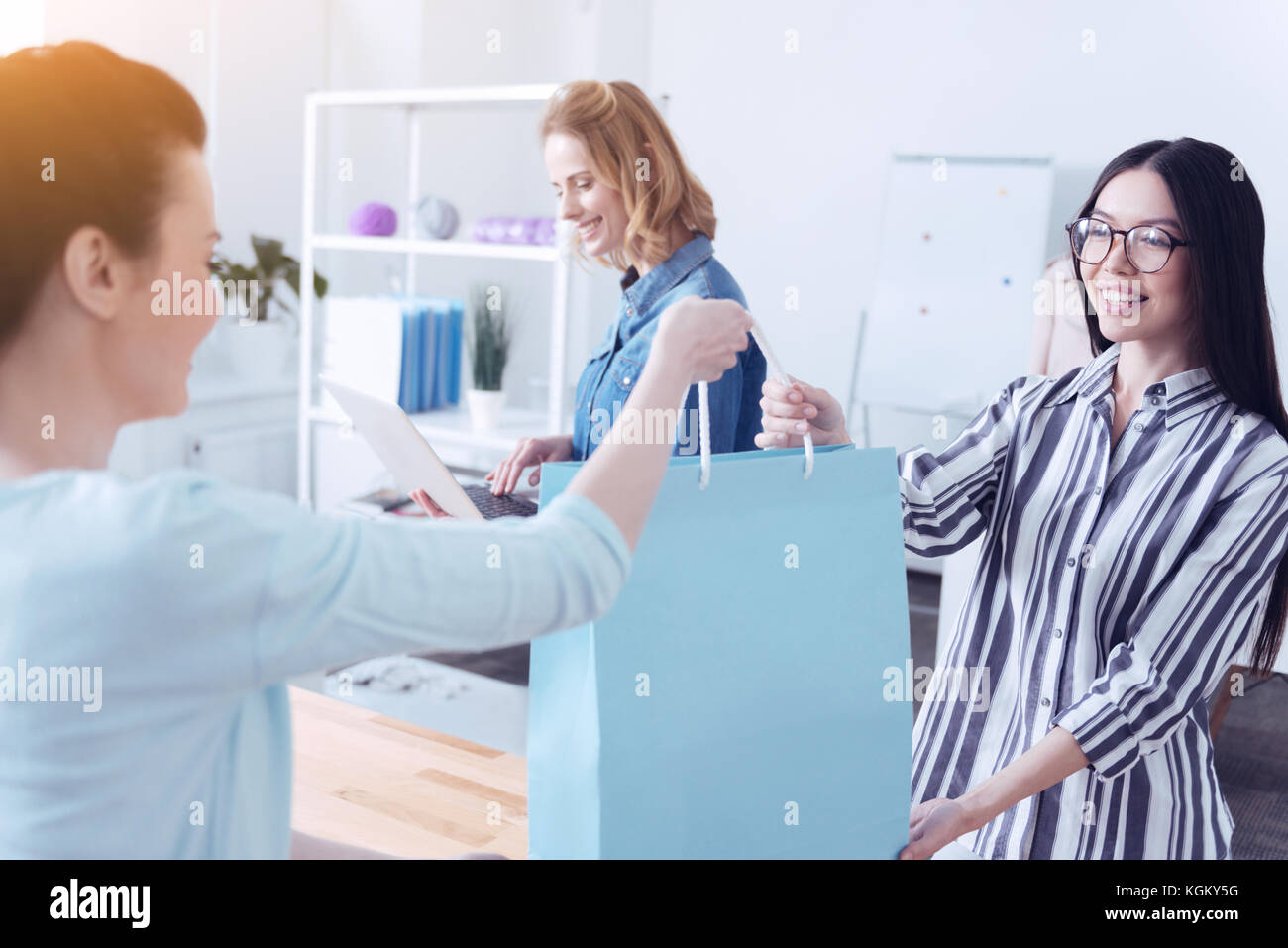 Satisfied client getting her order in a popular atelier Stock Photo - Alamy