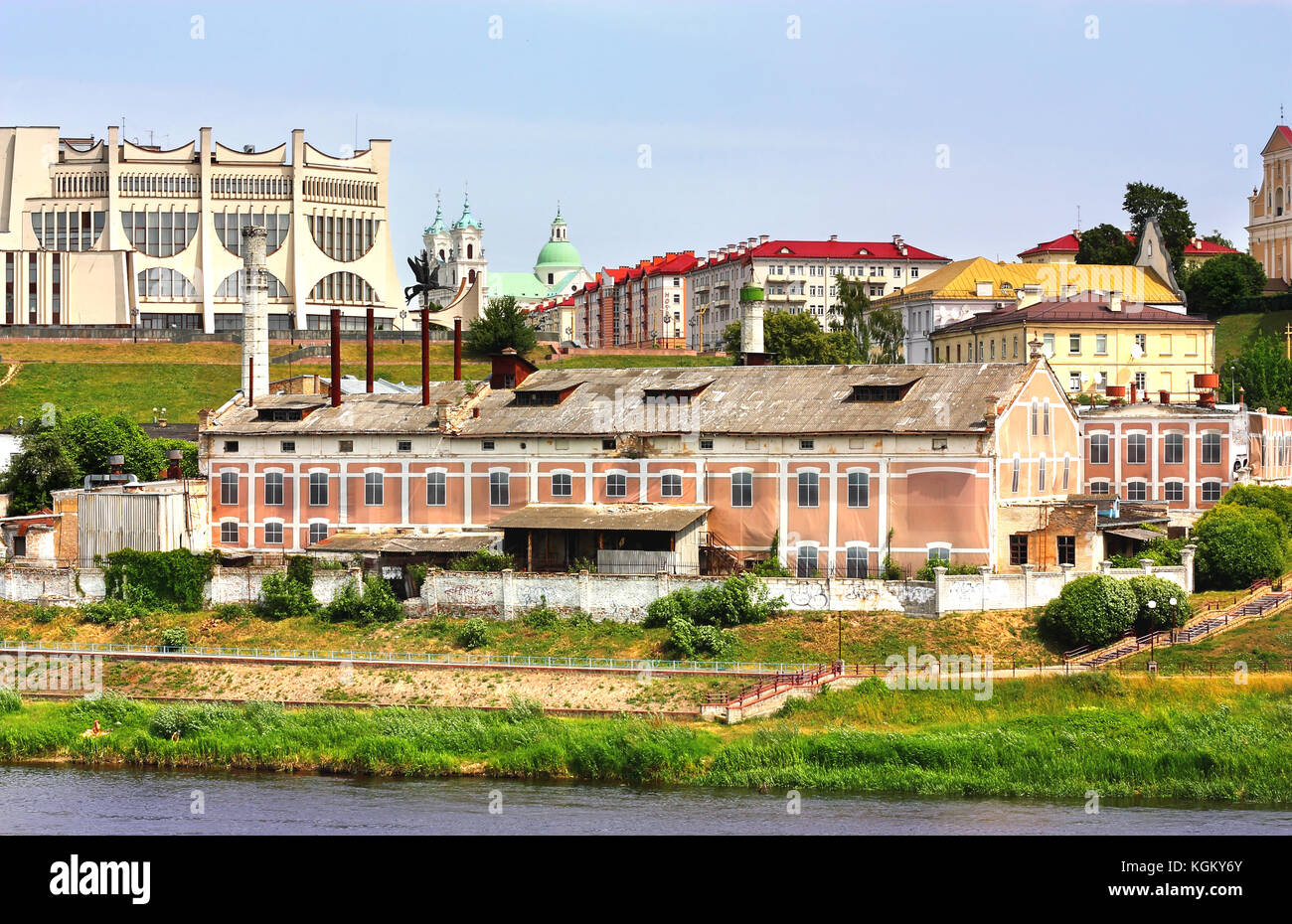 Surrounded by a fence old time factory buildings on the background of a ...