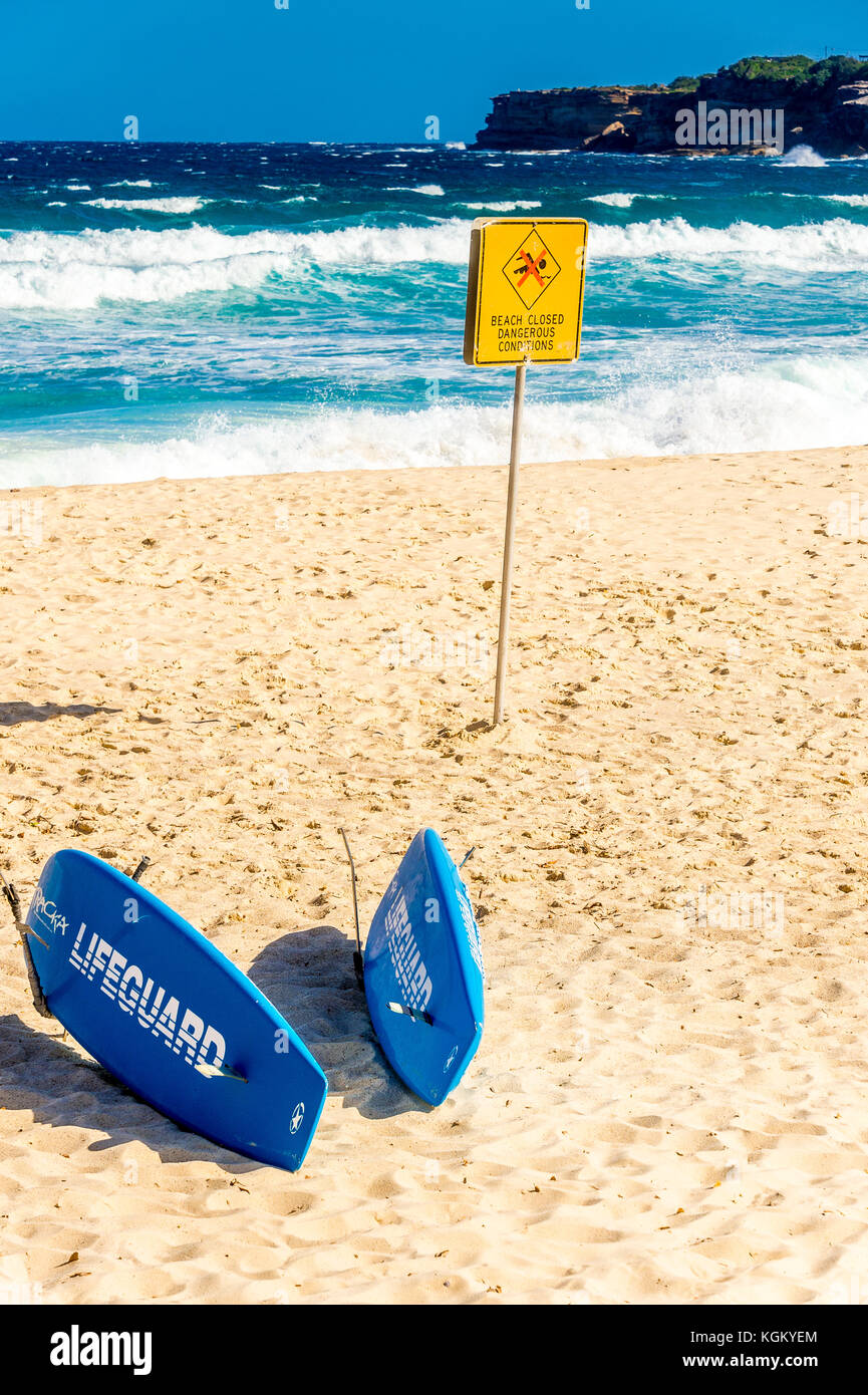 Lifeguard Rescue Boards rest on the sand with dangerous surf conditions ...