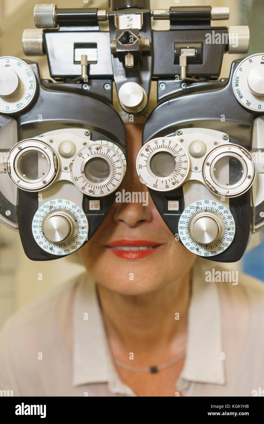 Close-up of smiling senior woman getting vision examination at clinic ...