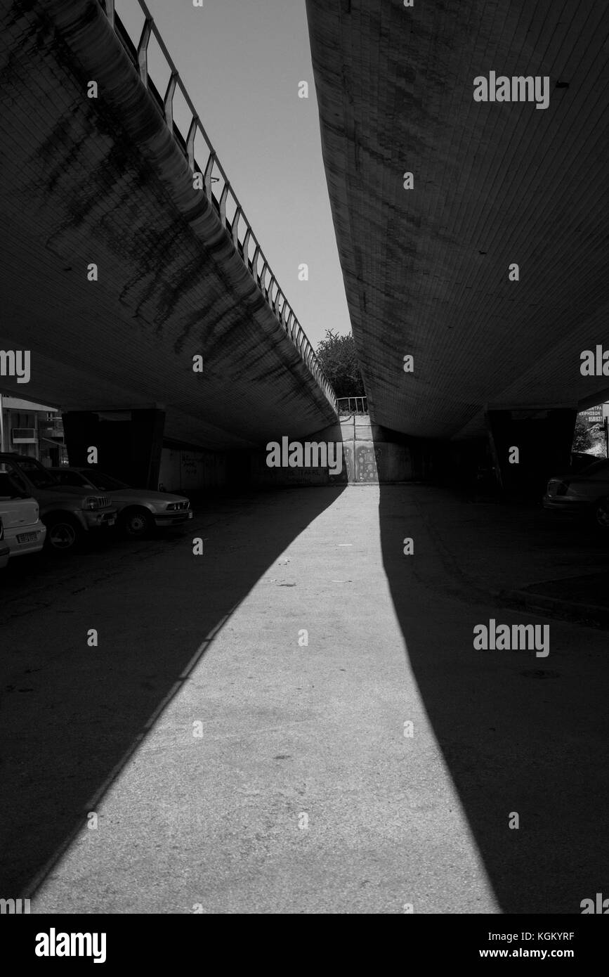 Cars parked under overpass on sunny day Stock Photo - Alamy