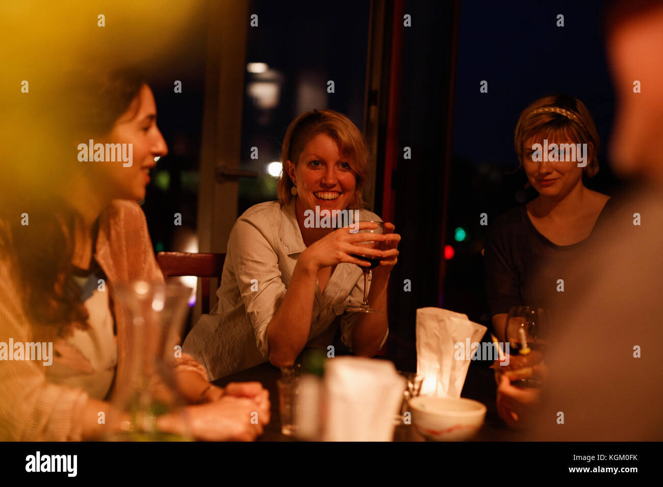 Happy female friends enjoying birthday party at home Stock Photo - Alamy