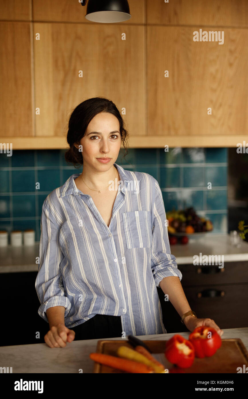 Woman standing at kitchen island hi-res stock photography and images ...