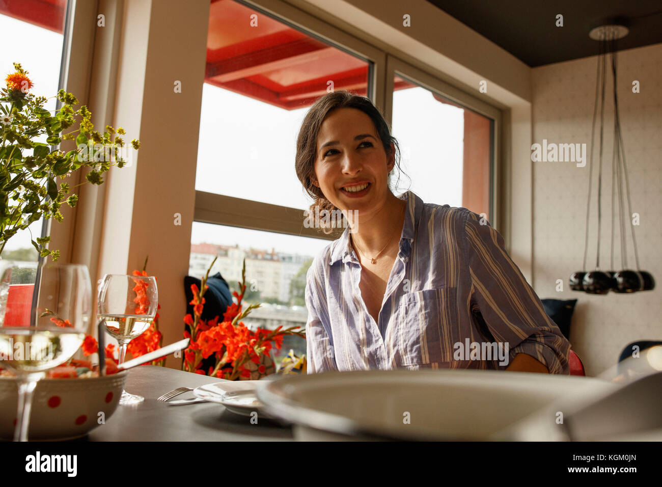 Young woman sitting dining table hi-res stock photography and images ...