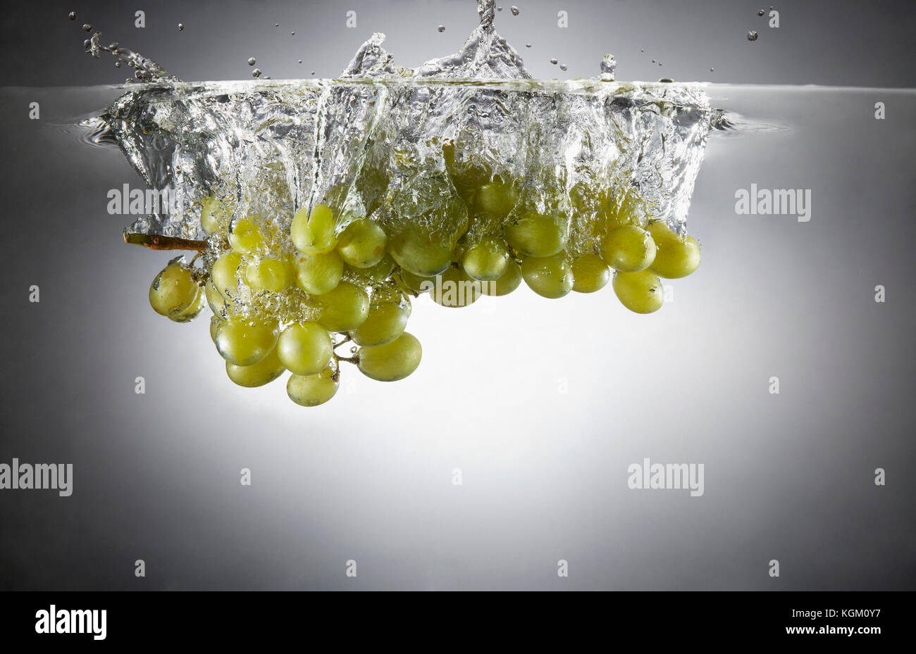 Bunch of green grapes in splashing water Stock Photo - Alamy