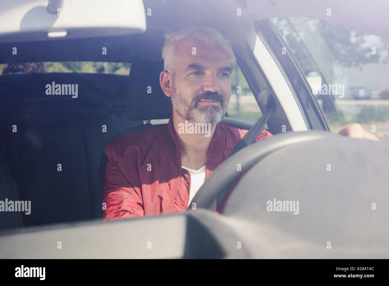 Mature man driving car seen through windshield Stock Photo - Alamy