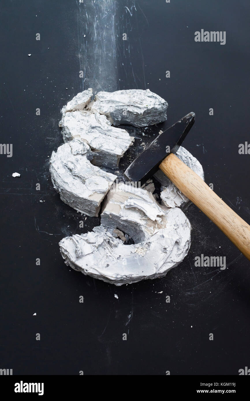 High angle view of broken concrete section sign with hammer on table ...