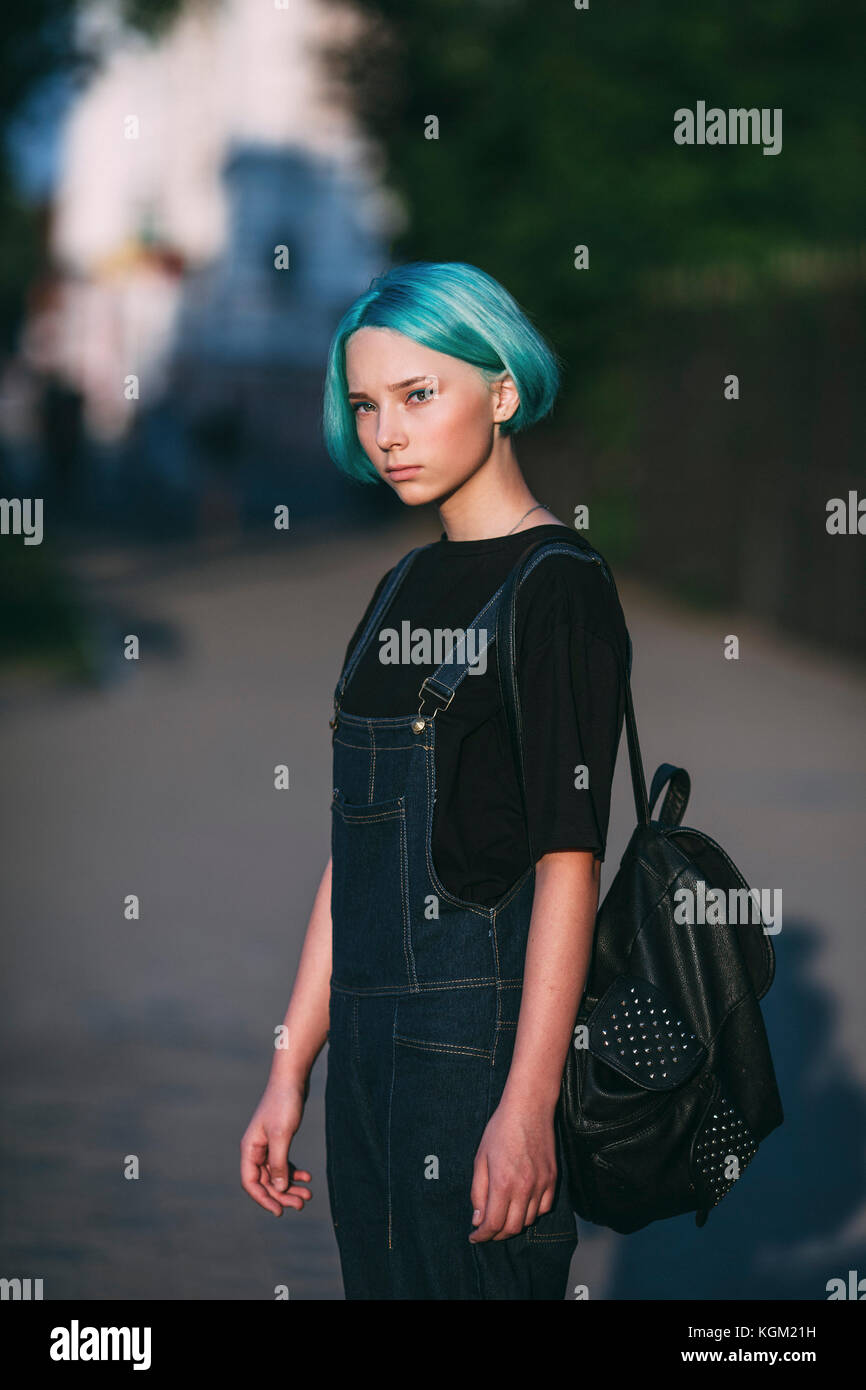 Portrait of teenage girl carrying backpack while standing on road Stock ...