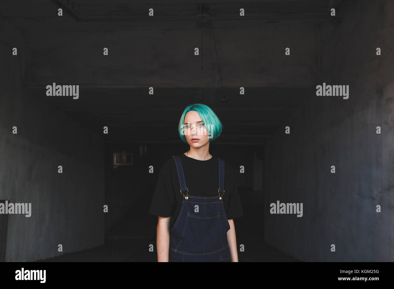 Portrait of teenage girl standing in basement Stock Photo - Alamy