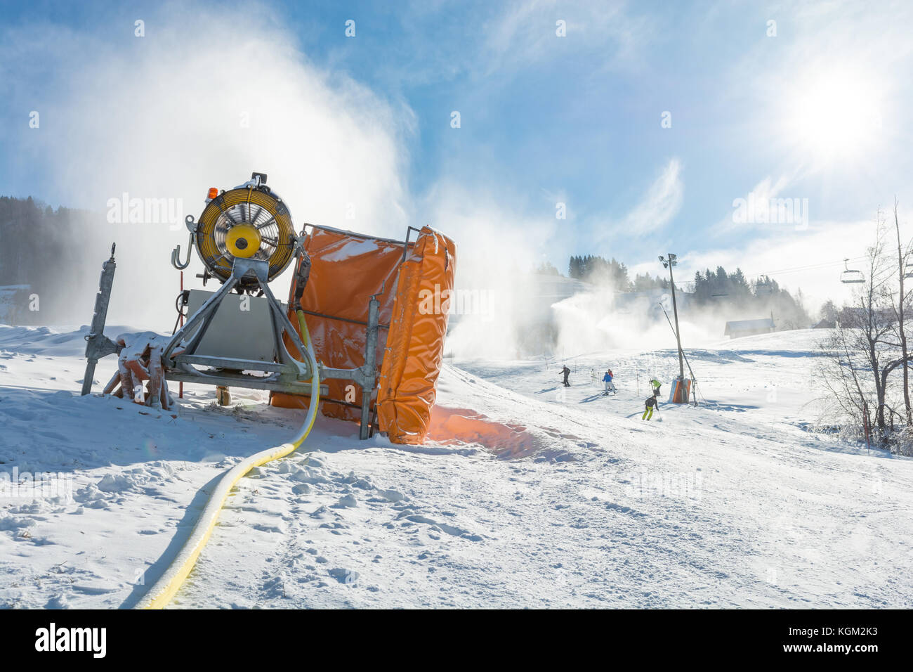 Ski resort with snow gun making new surface Stock Photo - Alamy