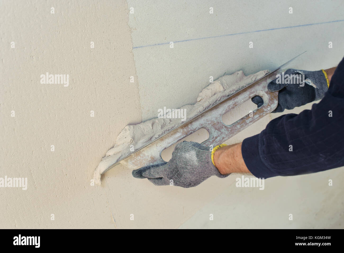 Gypsum puttying manually. Man's hands with a trowel applied and smooth ...