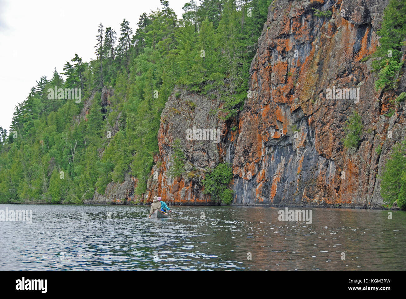 Canoeing by a Sheer Rock Wall in Quetico Provincial Park Stock Photo ...