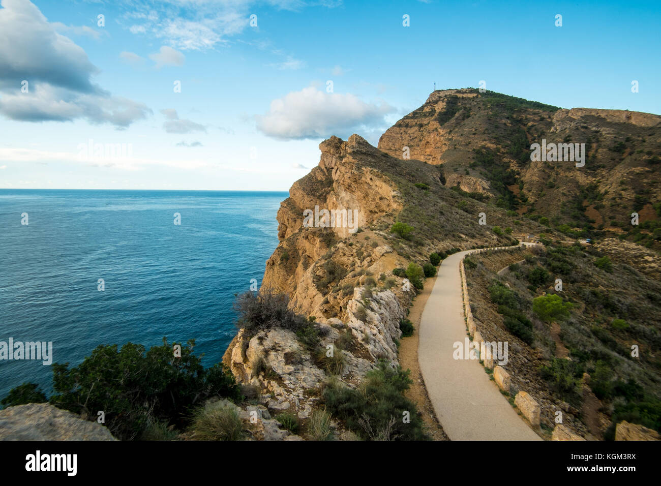 Sierra Helada cliffs and scenic road to its lighthouse overlooking ...