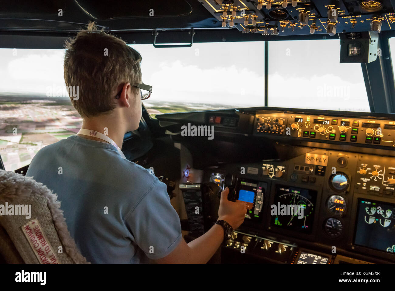 WARSAW, POLAND, August 5, 2017: Young man piloting a plane in flight ...